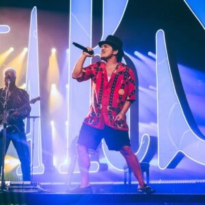 Bruno Mars performs with his band, The Hooligans, and frequently draws ...